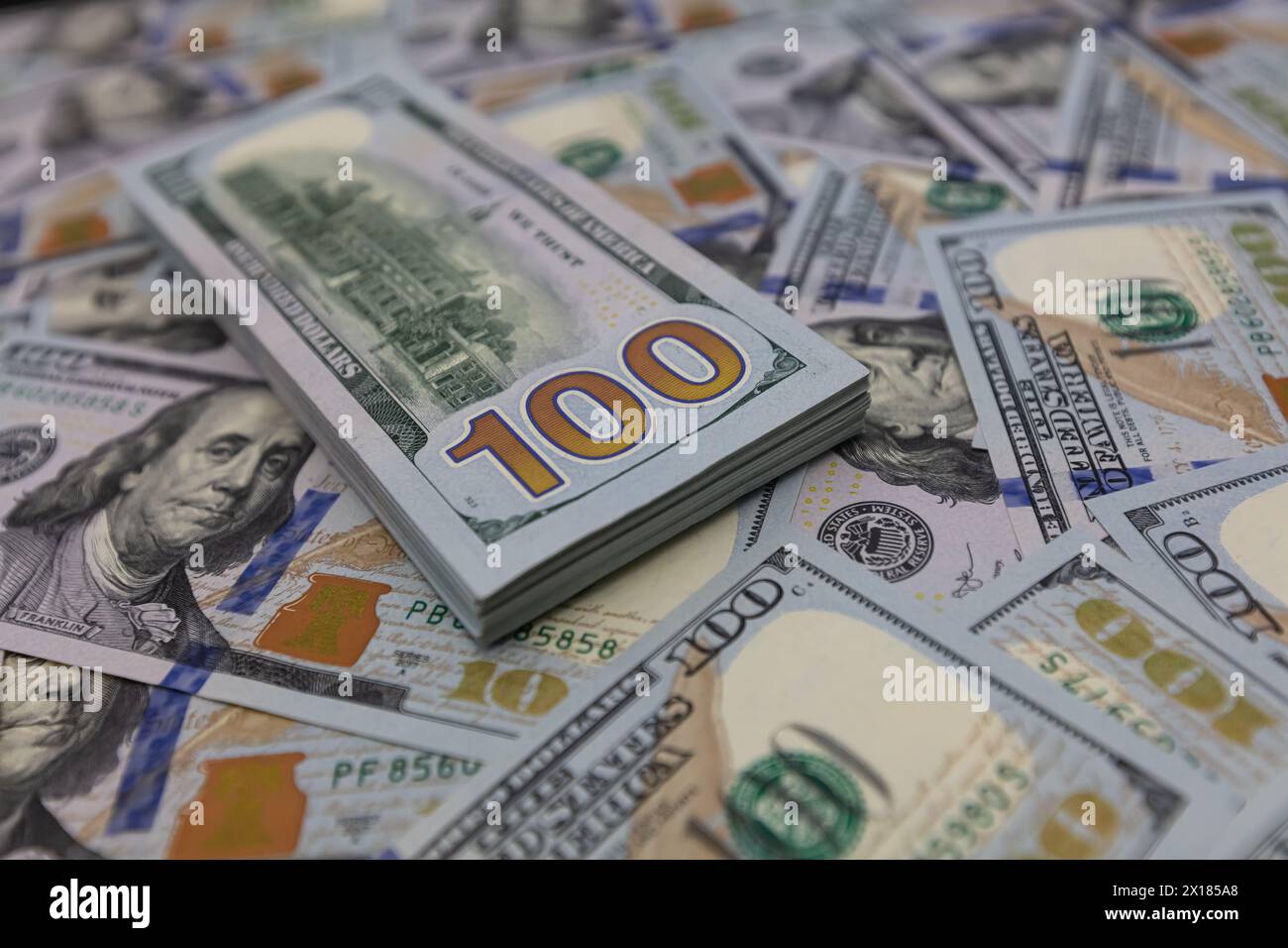 Pile of US 100 dollar banknotes on dollars background for design ...