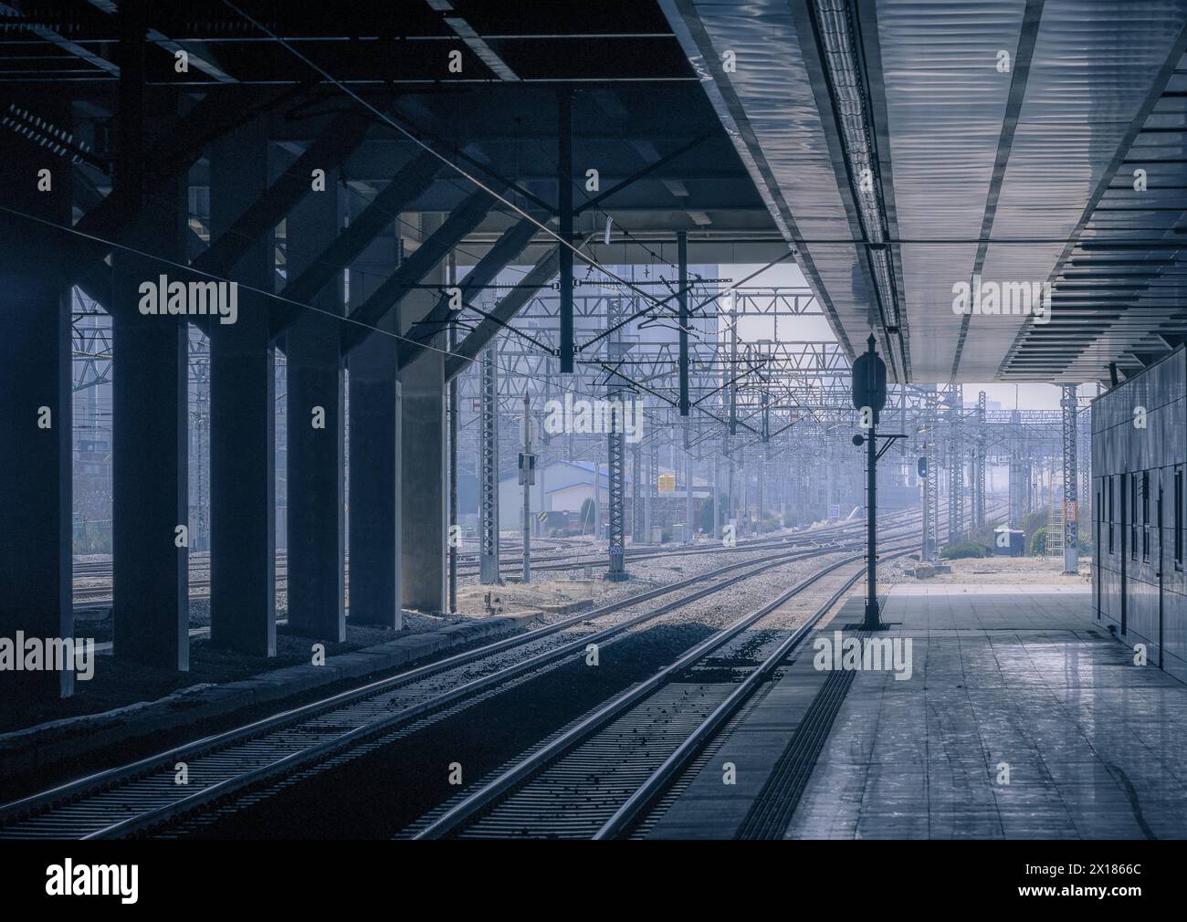 Subway platform with metal cabinets against the wall and tracks leading ...