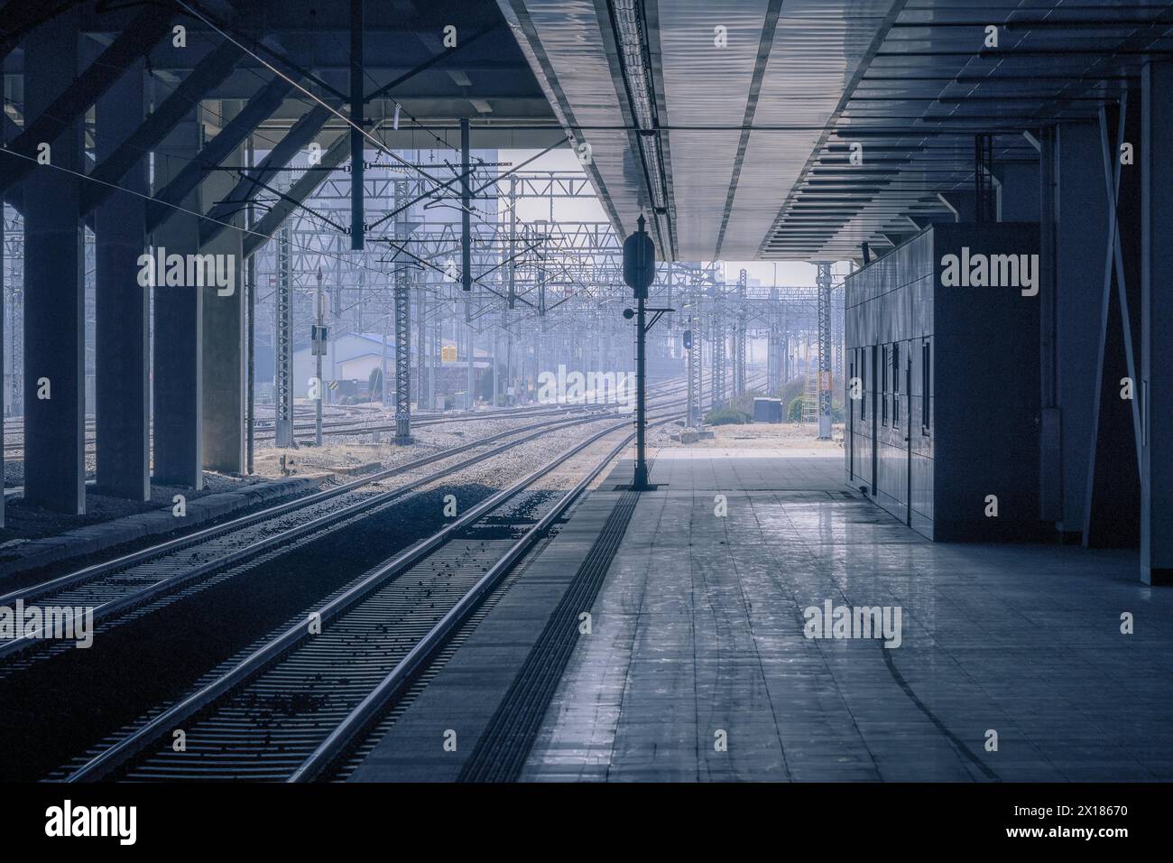 Subway platform with metal cabinets against the wall and tracks leading ...