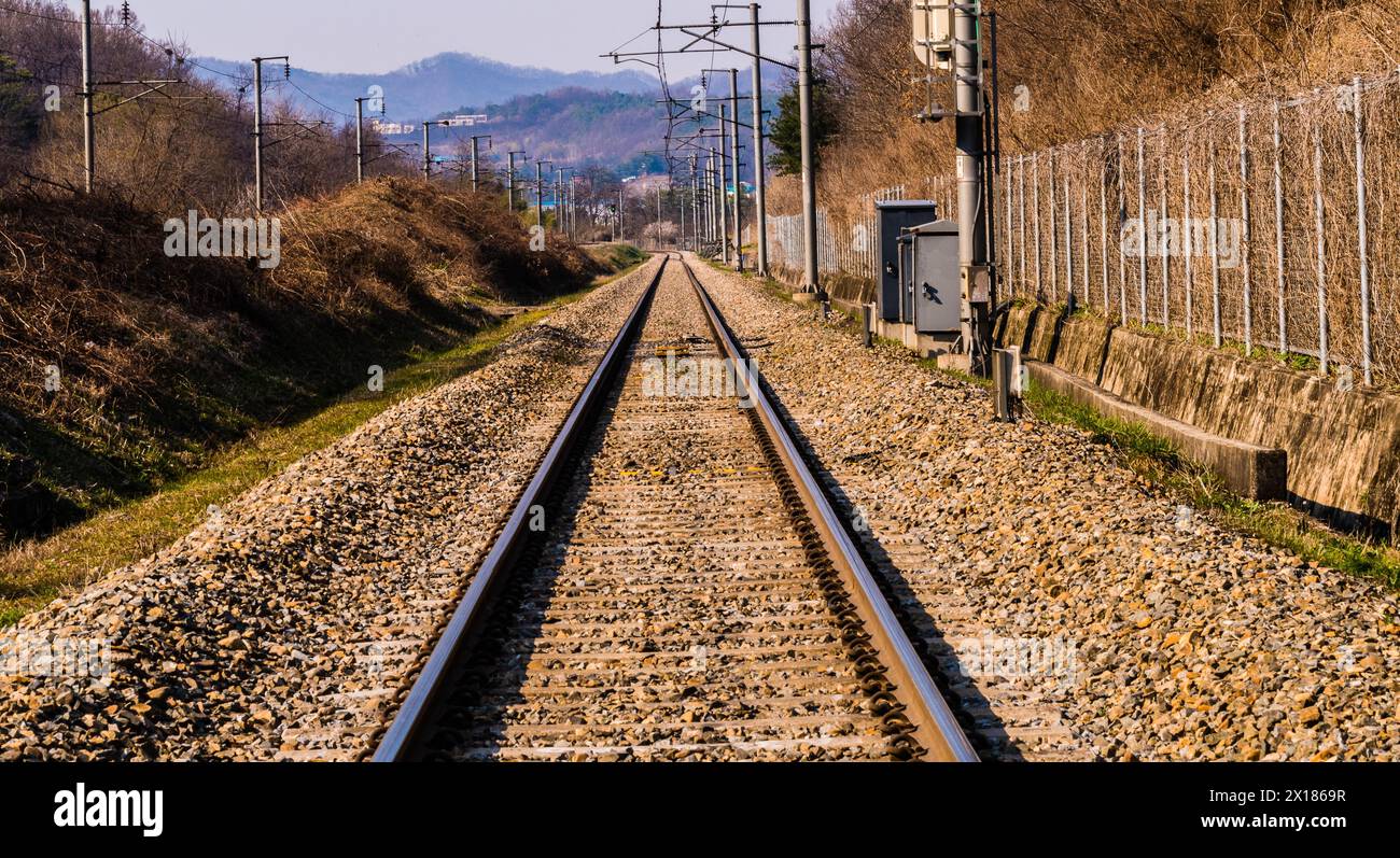 Landscape of railroad tracks running off into the distance with a small ...