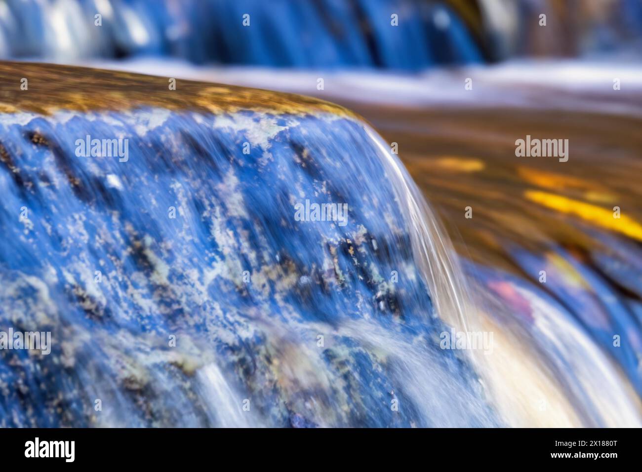Close up at running water over a rock in a stream Stock Photo - Alamy