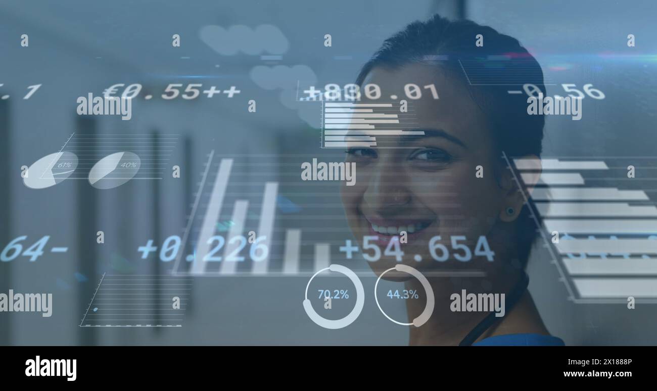 Image of financial data and graphs over happy biracial female doctor ...