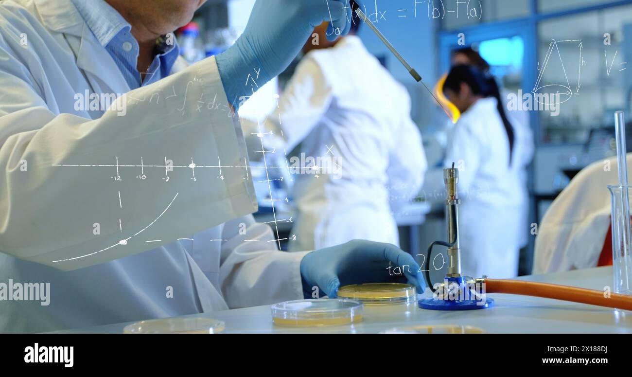 Image of mathematical equations over group of diverse scientists in lab ...