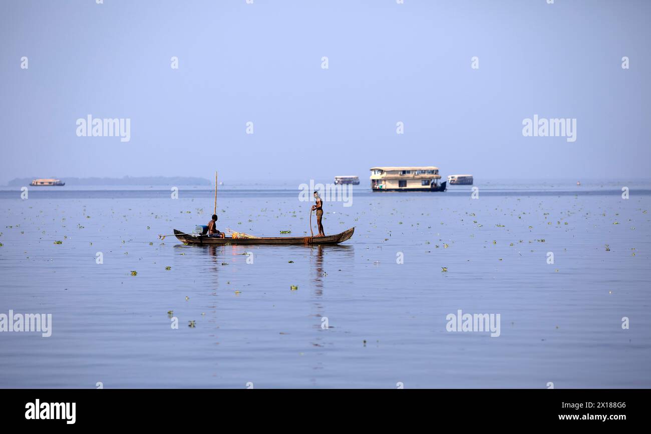 Fisherman on a small boat on the Vembanad Lake, canal system of the ...