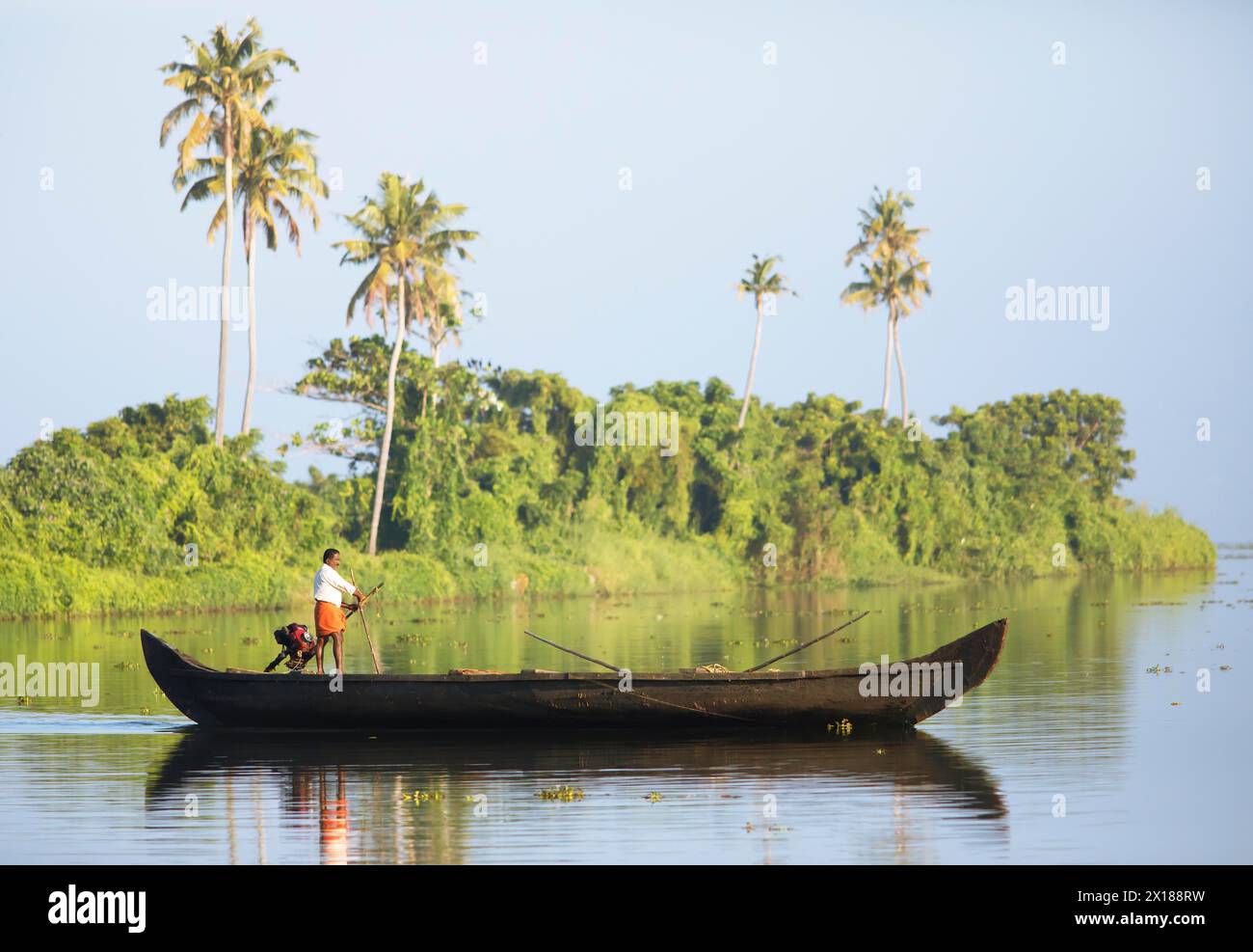 Fisherman in the morning with a boat on the Vembanad Lake, canal system ...