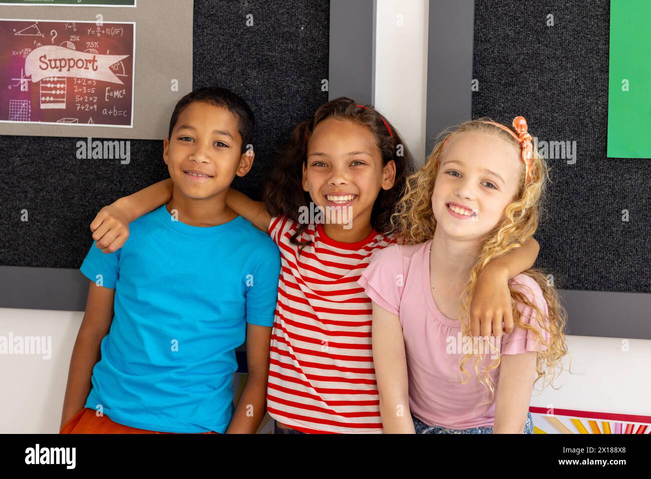 In school, diverse group of young friends are sitting together in a ...