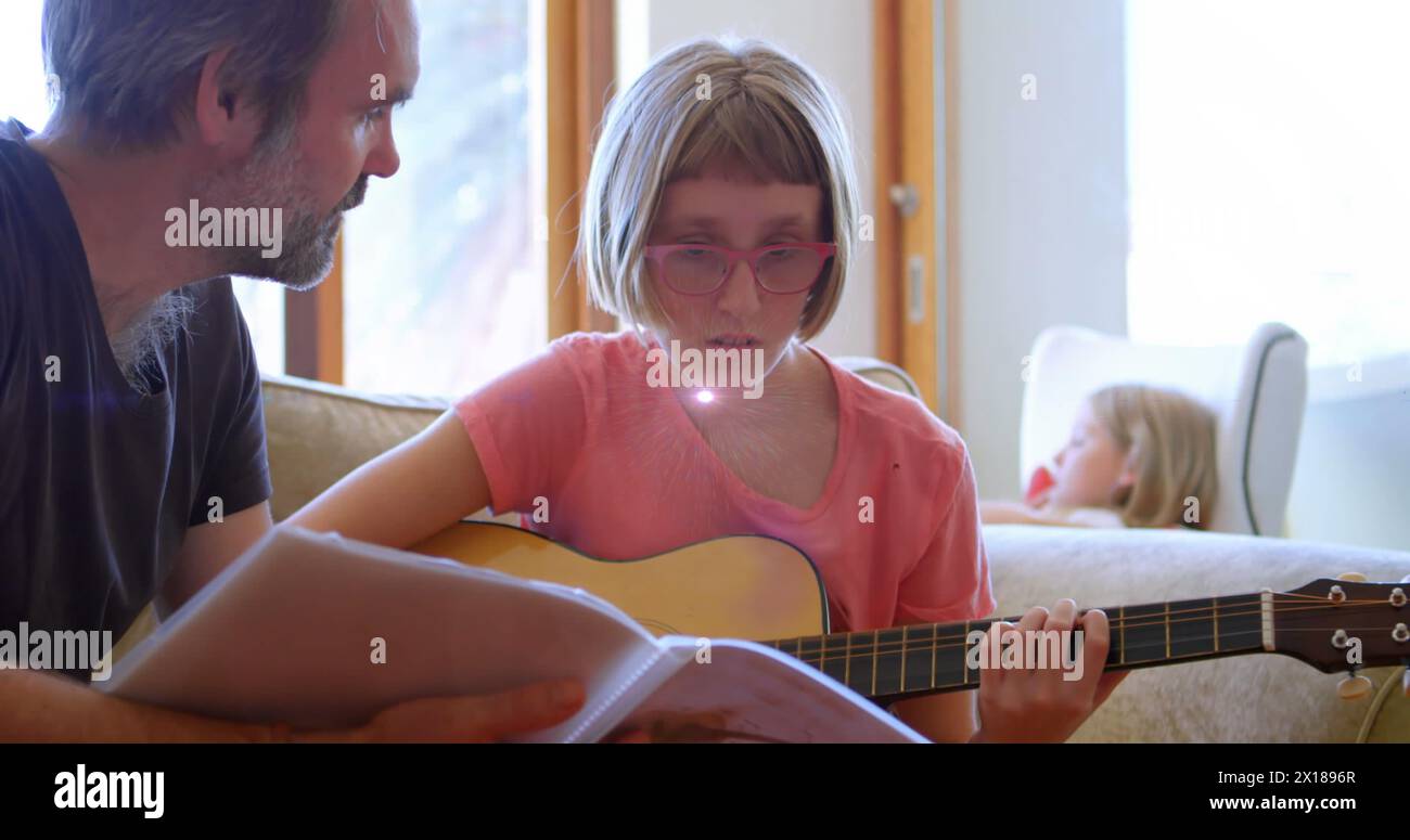 Image of light flashing over caucasian father learning daughter how to ...