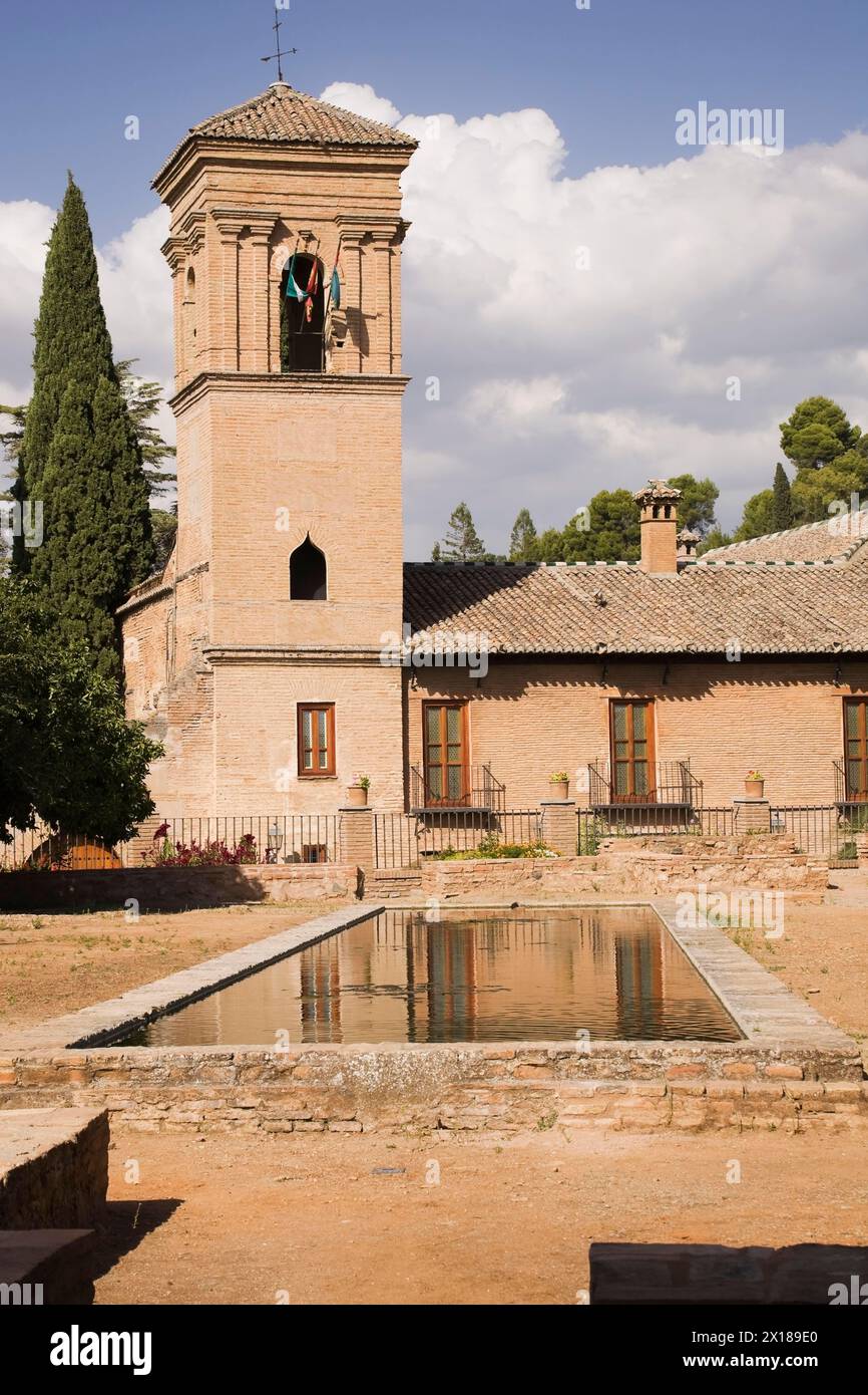 Ornamental garden with mirror water basin and a tower on the Alhambra ...