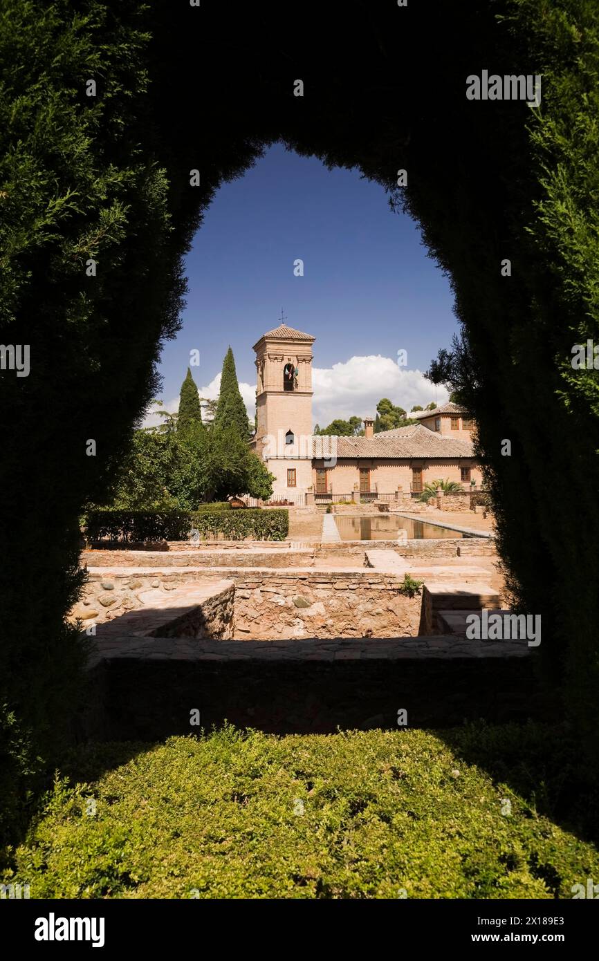 Ornamental garden with mirror water basin and a tower on the Alhambra ...