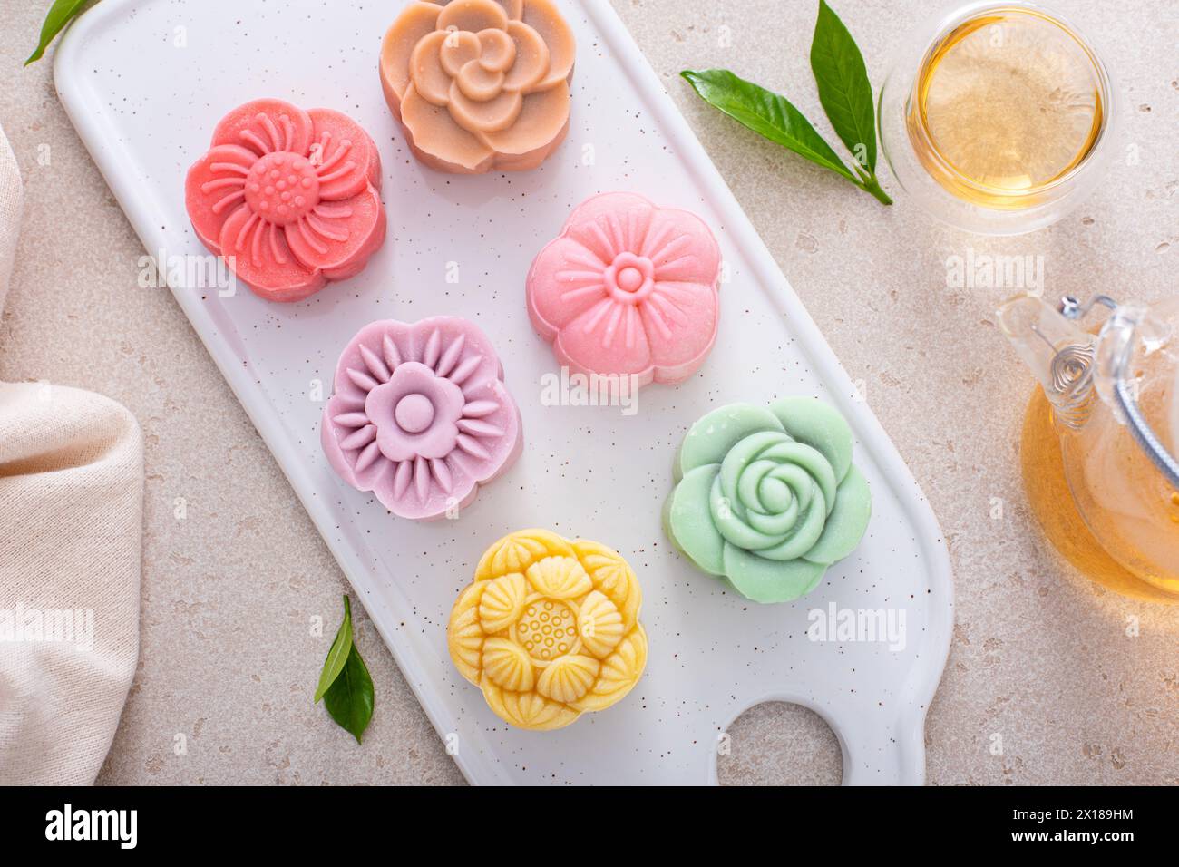 Traditional snow skin mooncakes for a Chinese Mid-Autumn Festival or Moon festival served with ...