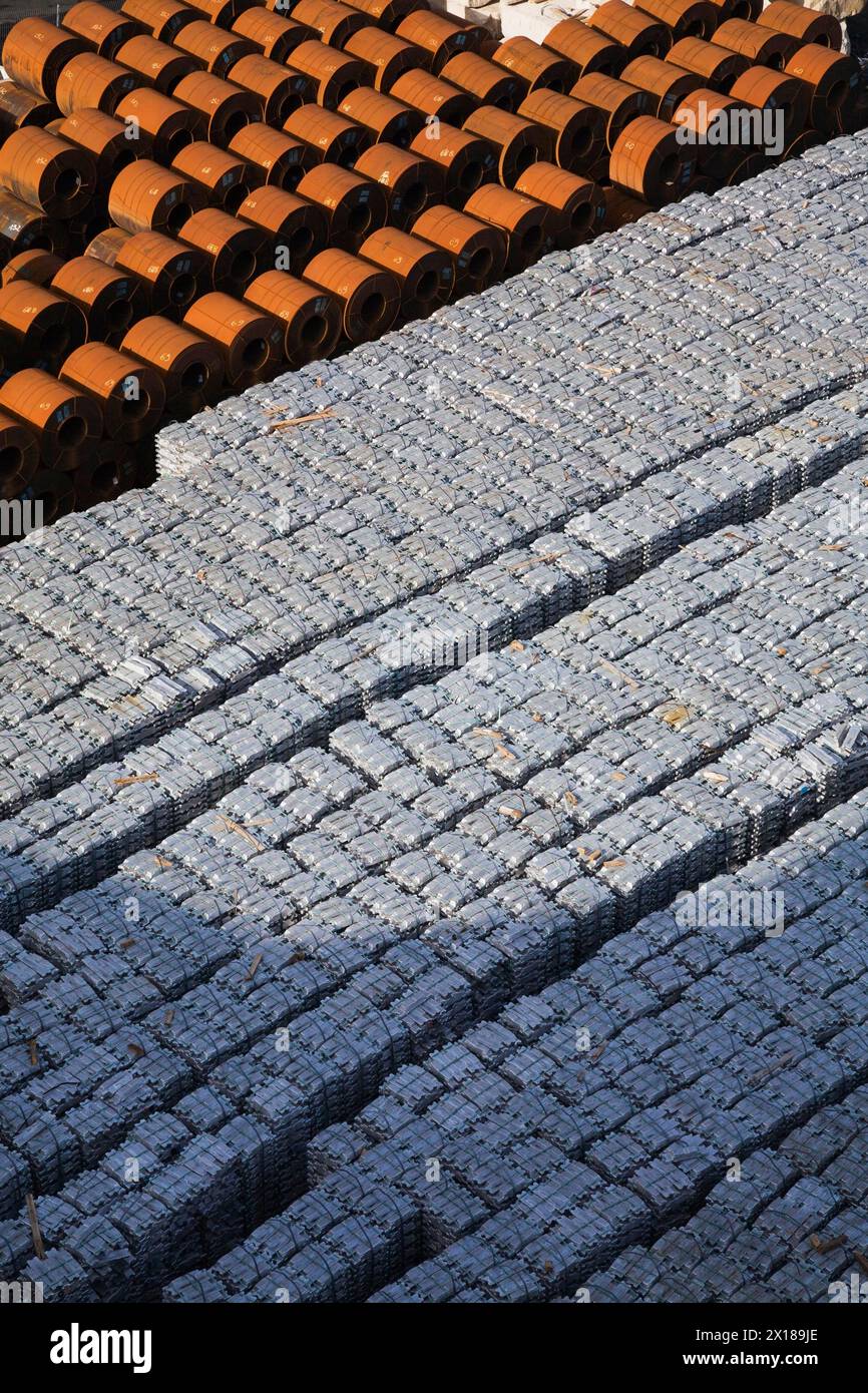 Top view of aluminium ingots and coils of flat rolled steel waiting for ...