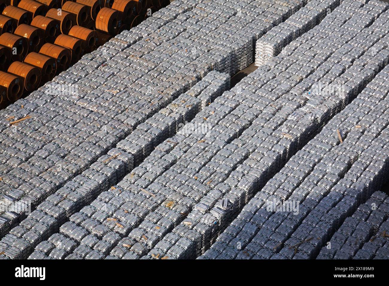 Top view of aluminium ingots and coils of flat rolled steel waiting for ...