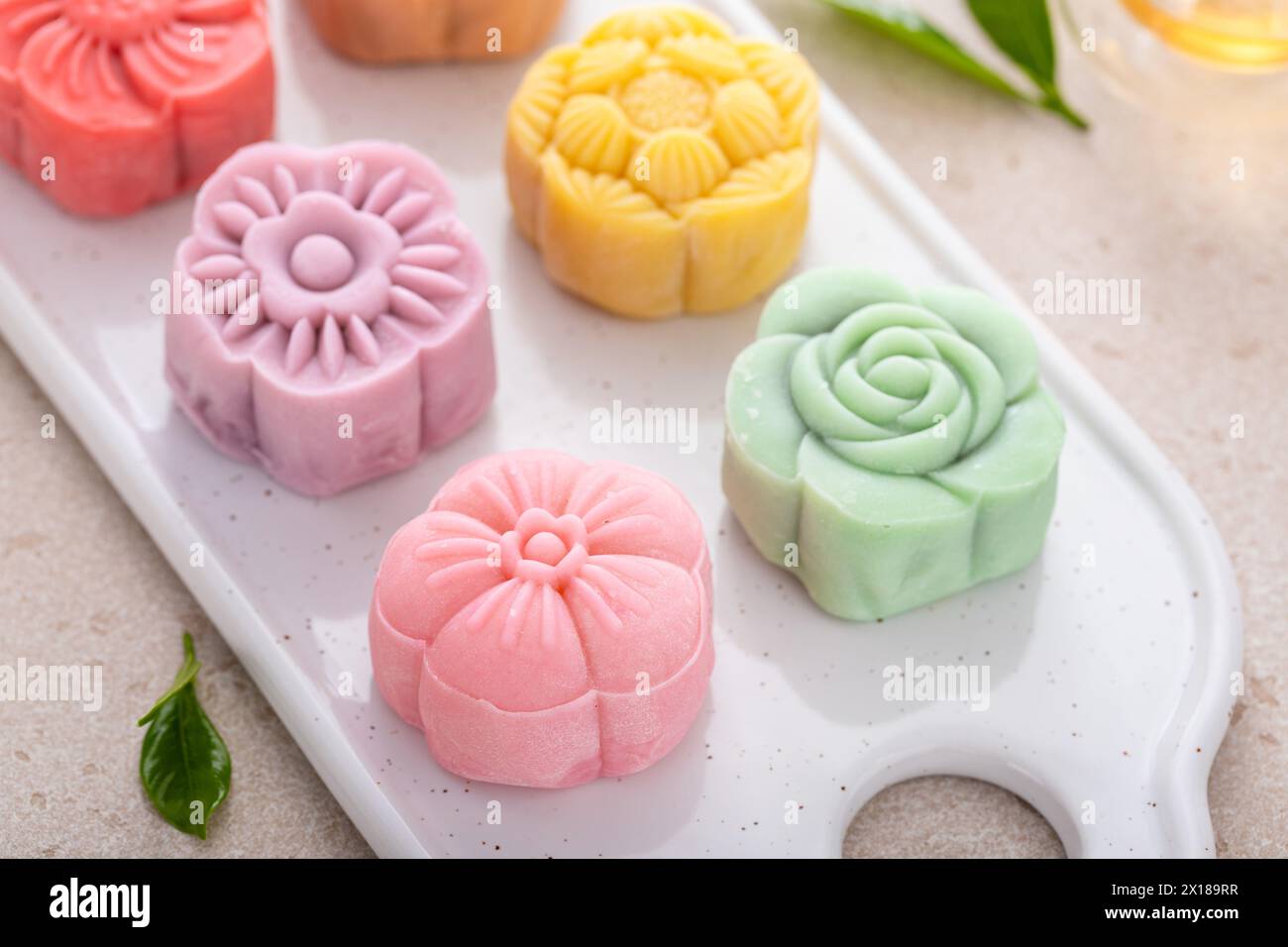 Traditional snow skin mooncakes for a Chinese Mid-Autumn Festival or Moon festival served with ...
