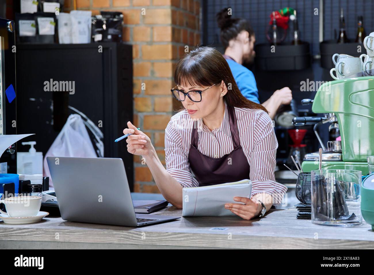 Colleagues, partners, man and woman behind counter in coffee shop Stock ...