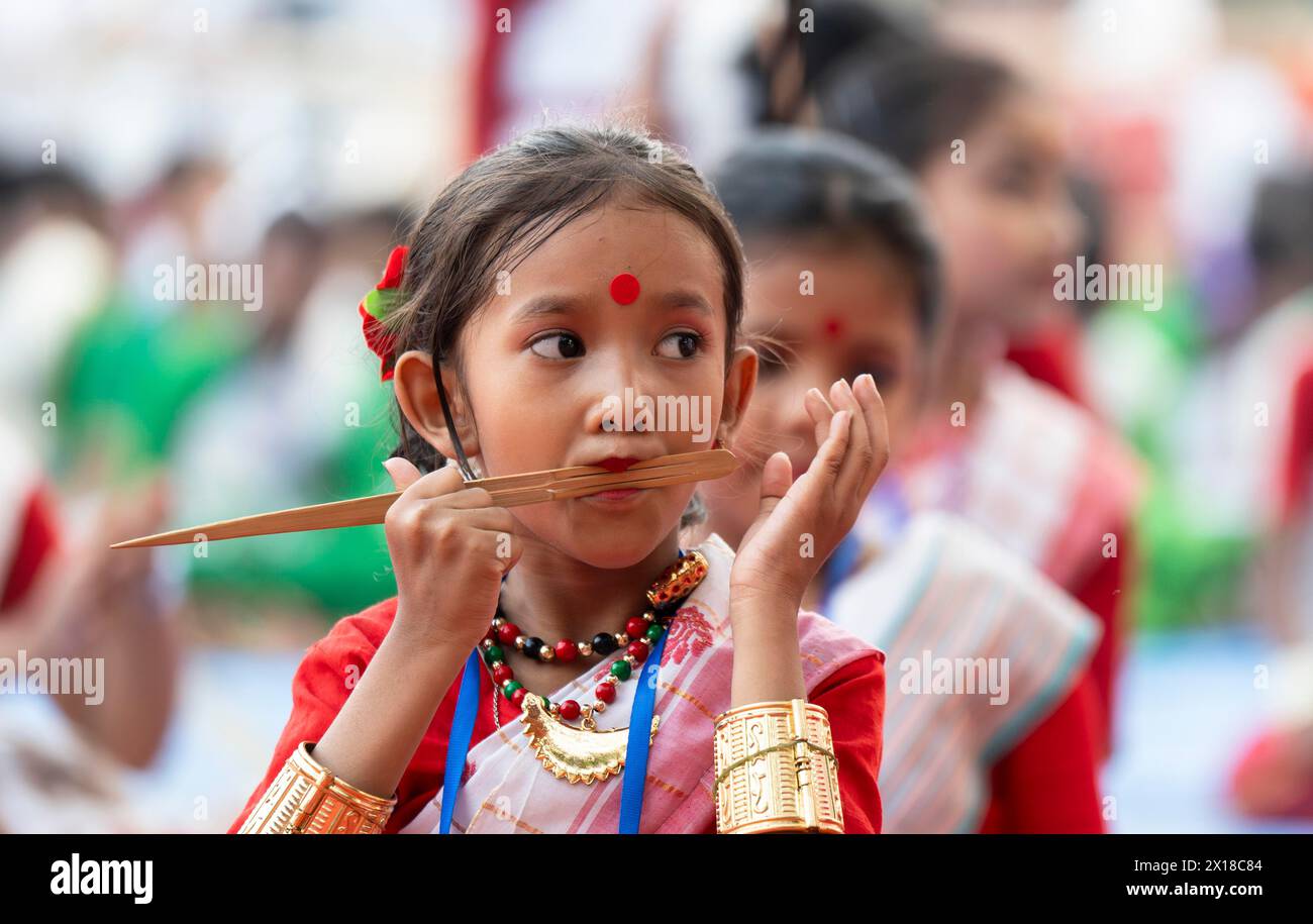 A girl plays Gagana (musical instrument) as she participate in a Bihu ...