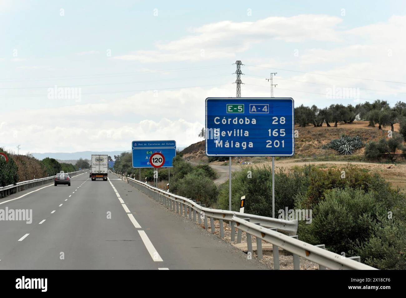 Motorway signs indicating distances and directions to cities, cars on ...