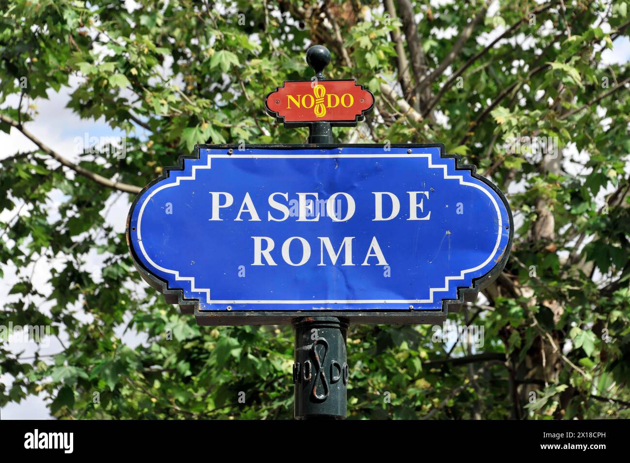 Seville, Blue and white street sign for Paseo de Roma with No8Do symbol ...
