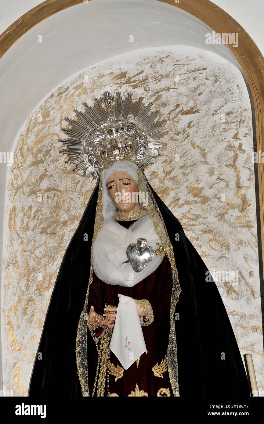 Near Arcos, figure of a saint in a black robe with heart and crown ...