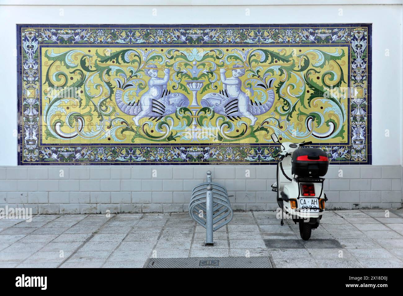 Seville, Colourful tile painting on a wall with a parked scooter in ...