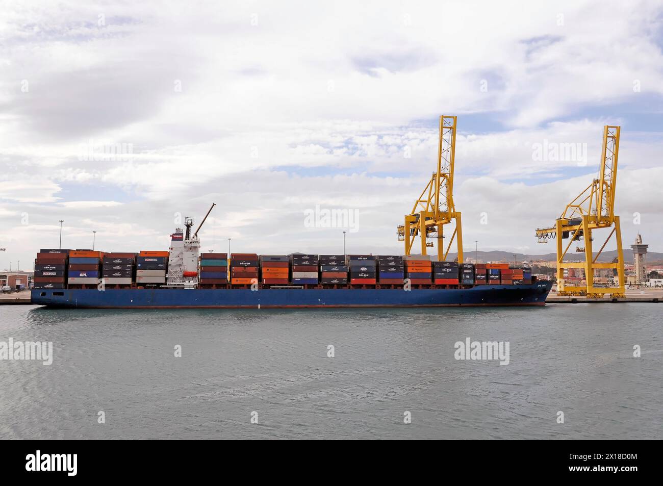 CEUTA, container ship at the quay with yellow harbour cranes loaded ...