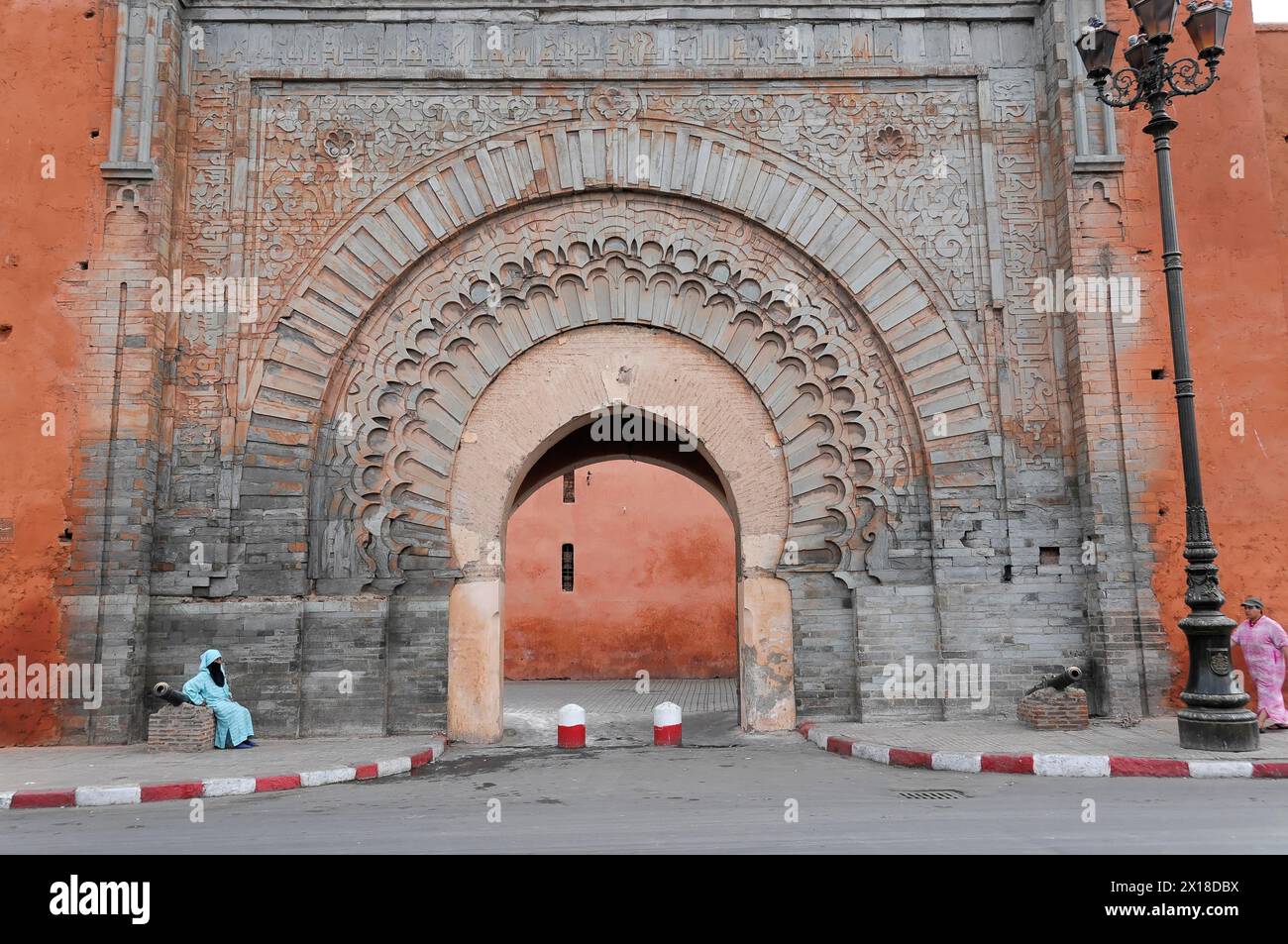 Marrakech, A historic Moroccan city gate made of sandstone with people ...