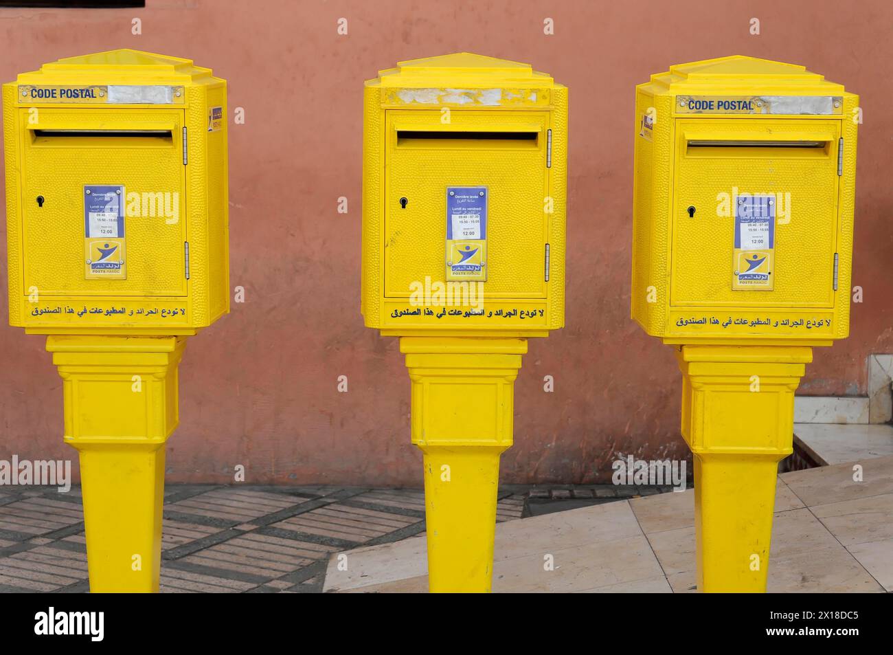 Marrakech, Three yellow Moroccan letterboxes next to each other on a ...