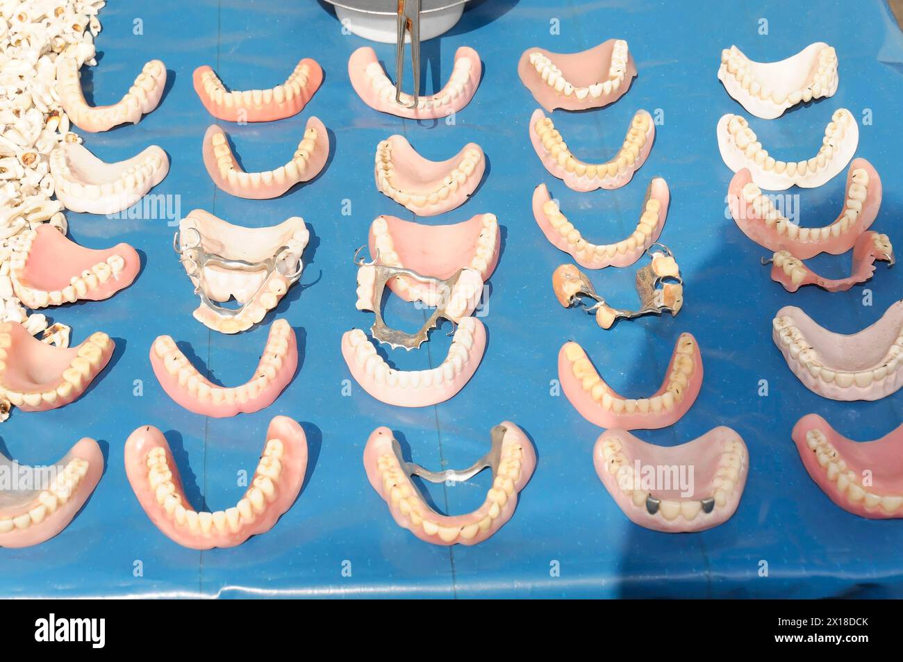 Marrakech, A collection of different denture models laid out on a table ...
