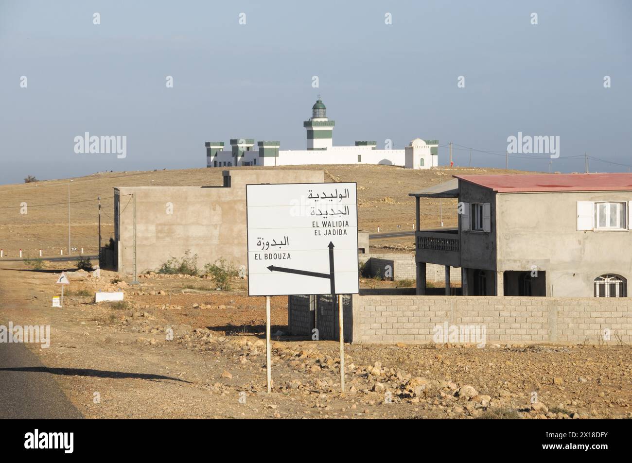 Near Essaouira, A lighthouse and buildings on a country road with ...