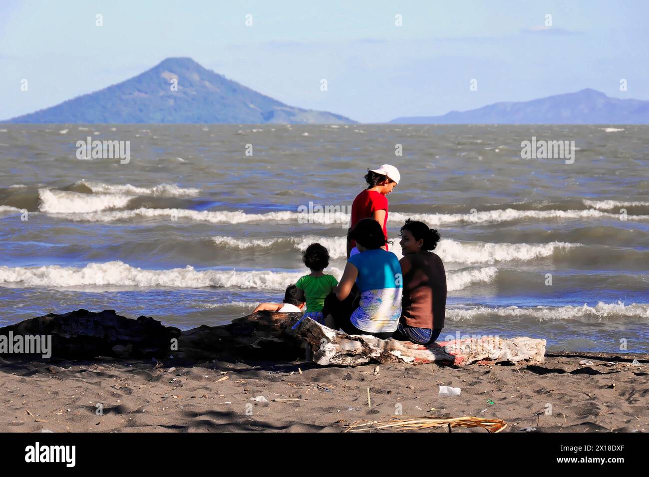 Momotombo Volcano, 1279m, Lake Managua, Leon, Nicaragua, A family sits ...