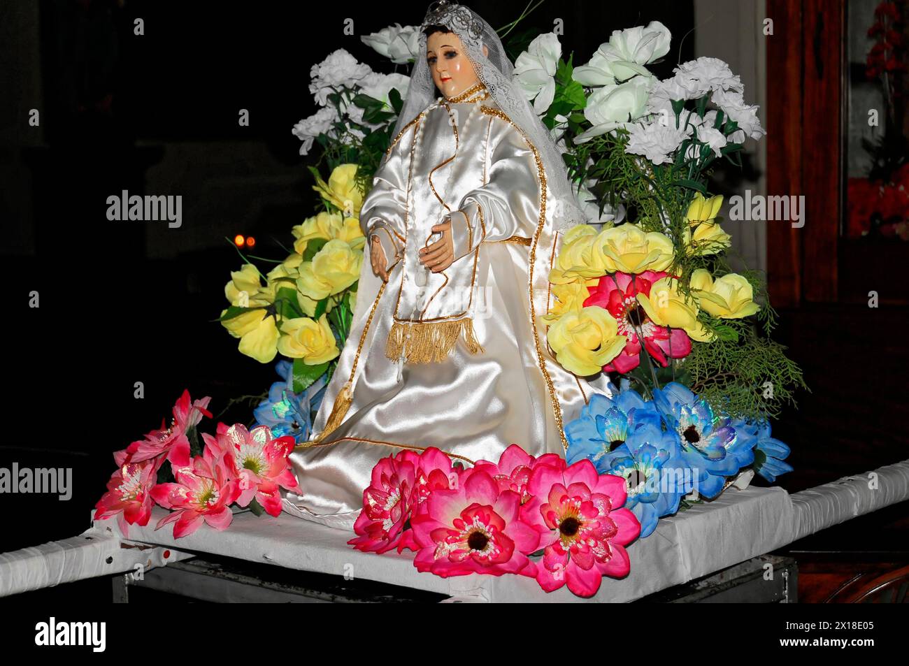 Leon, Nicaragua, A holy figure decorated with colourful flowers at a ...