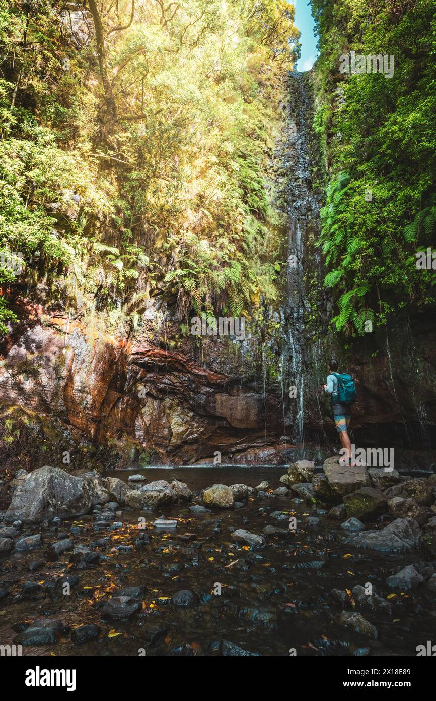 Description: Male toursit with backpack enjoys exploring green ...