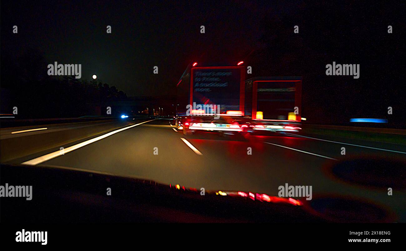 Night-time road scene with two lorries on the motorway, Bavaria ...