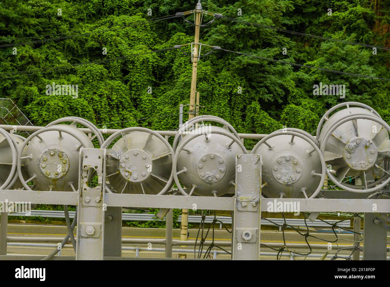 Row of depth charges on steel rack on battleship on display at ...
