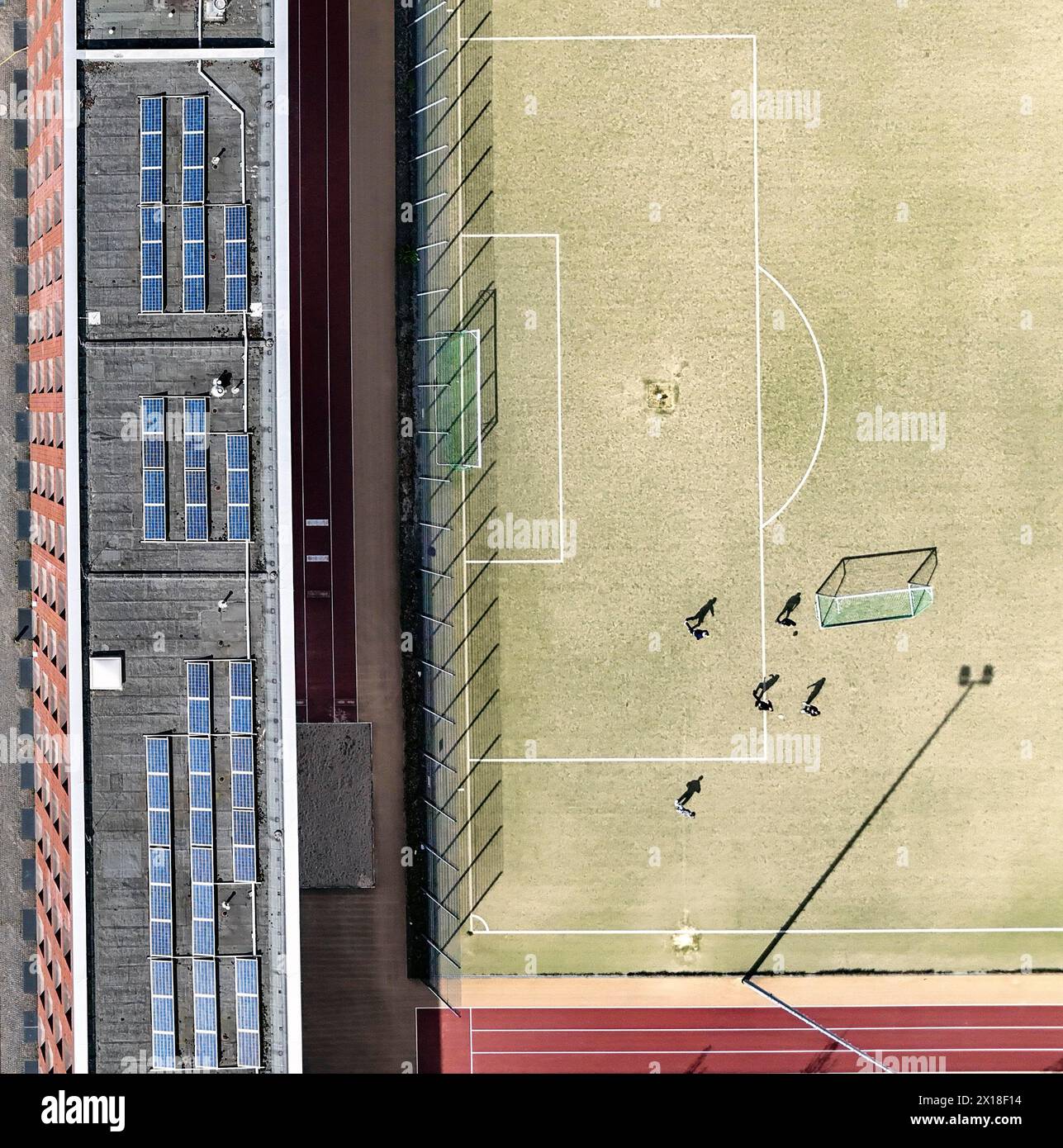 An aerial photo shows football players on a football pitch, next to ...