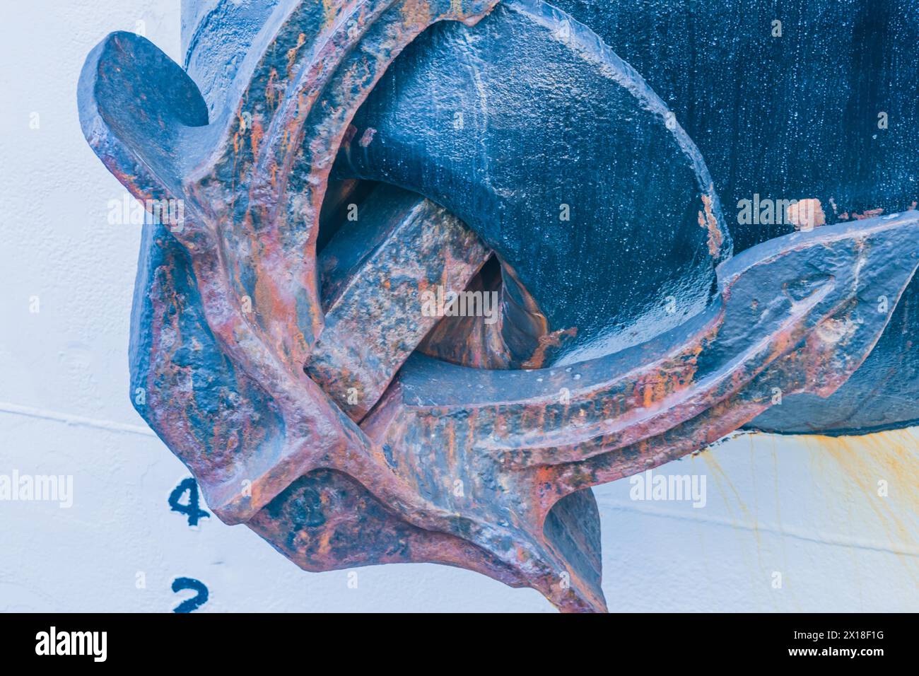Closeup of ship metal anchor retracted into the hull of the ship in ...