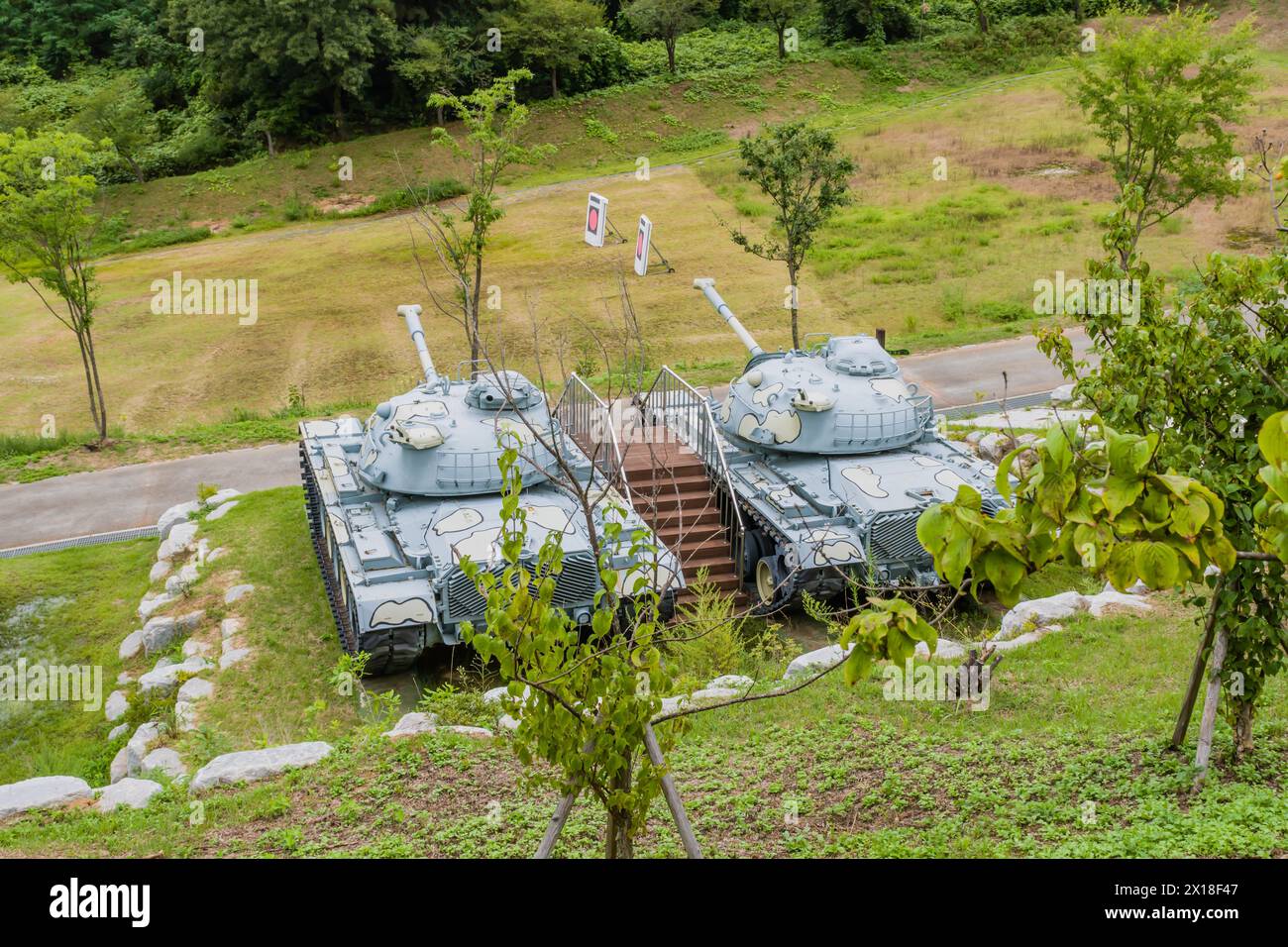 Military tanks with camouflage paint on display in public park near ...