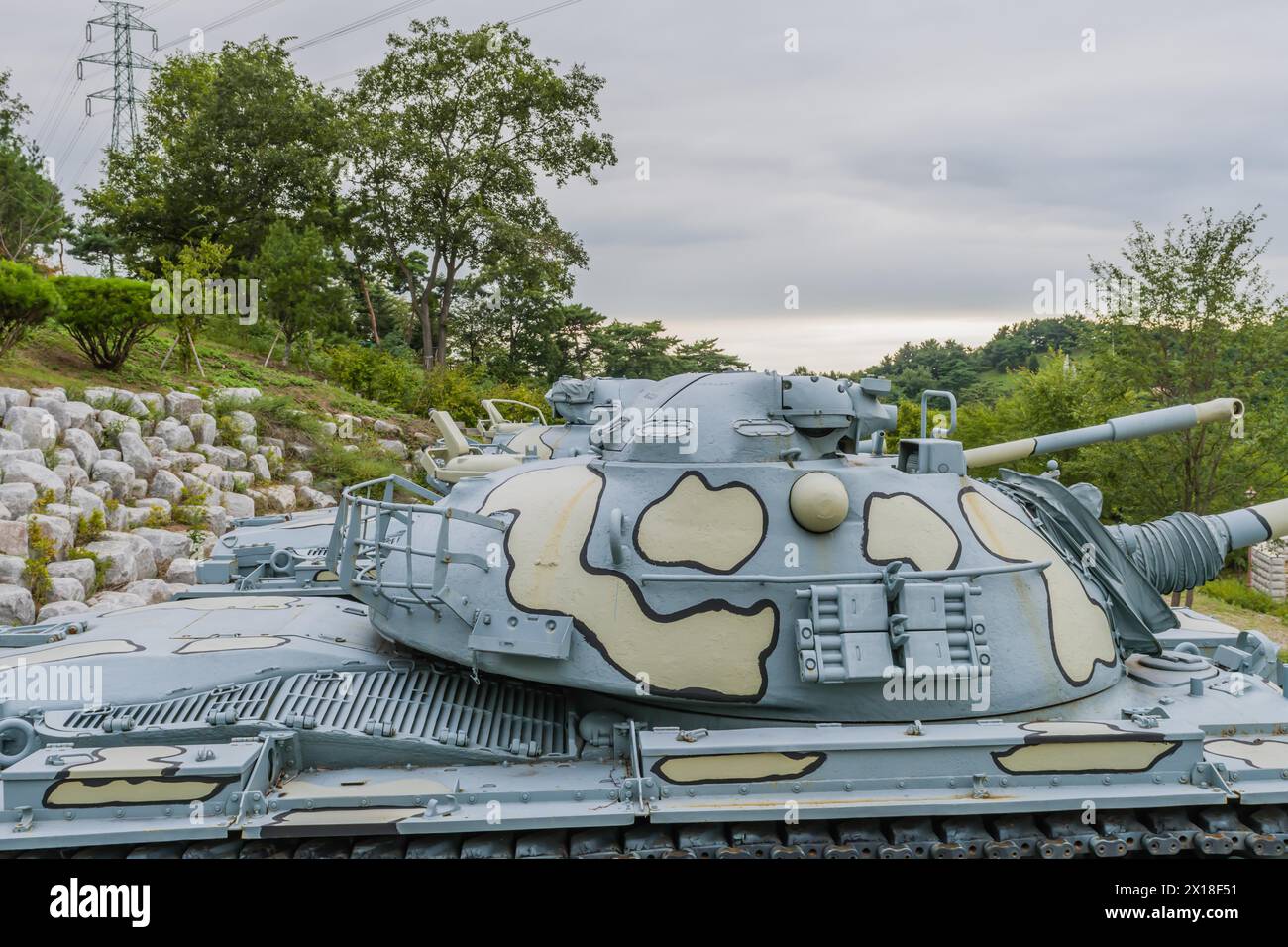 Closeup of gun turret on military tank with camouflage paint on display ...