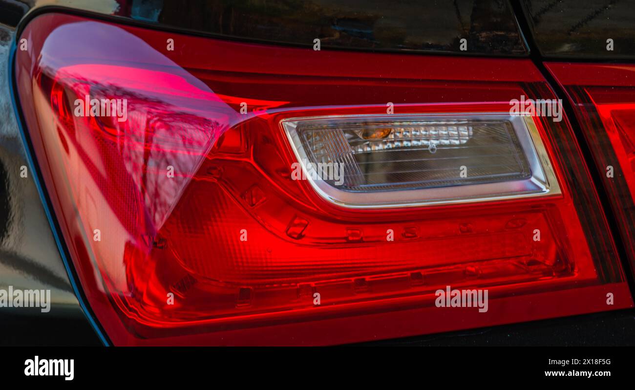 Closeup of red rear signal light cover with clear center piece with the ...