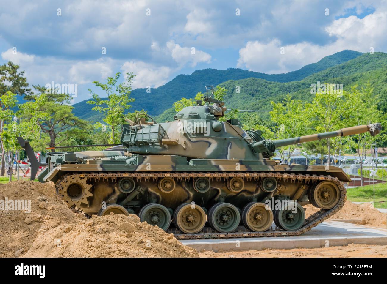 Side view of camouflaged tank used in Korean war on display in public ...