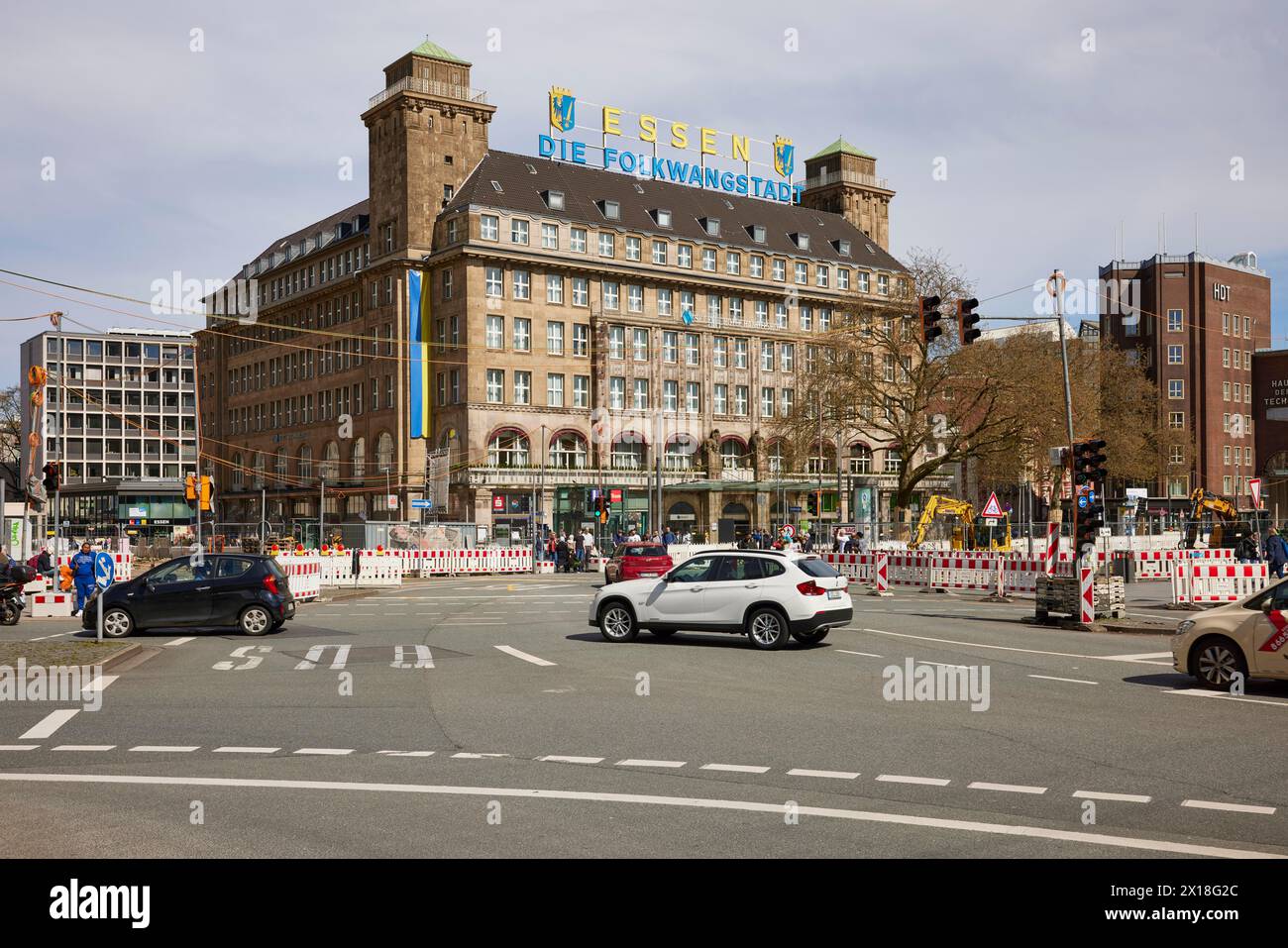 Main street with construction site and Hotel Handelshof with neon sign ...