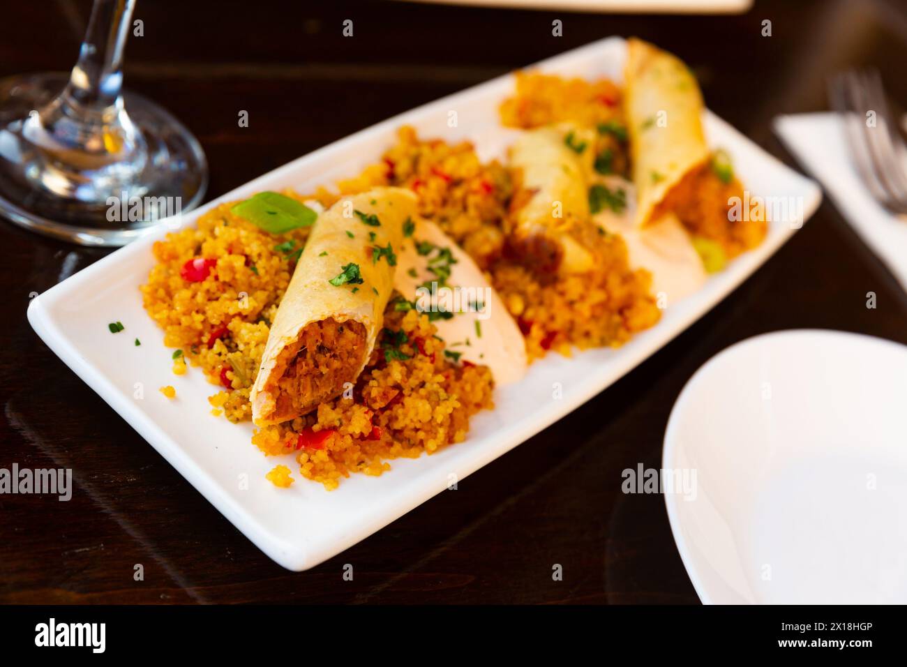 Tasty Moroccan lamb spring roll with harissa and couscous Stock Photo ...
