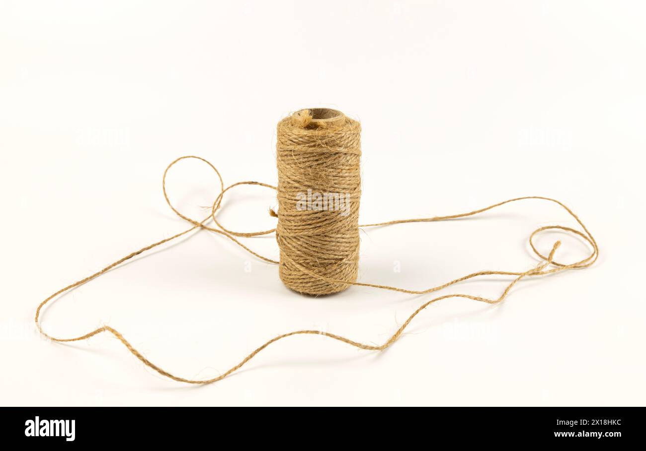 A spool of linen rope on a white background. The concept of textiles ...