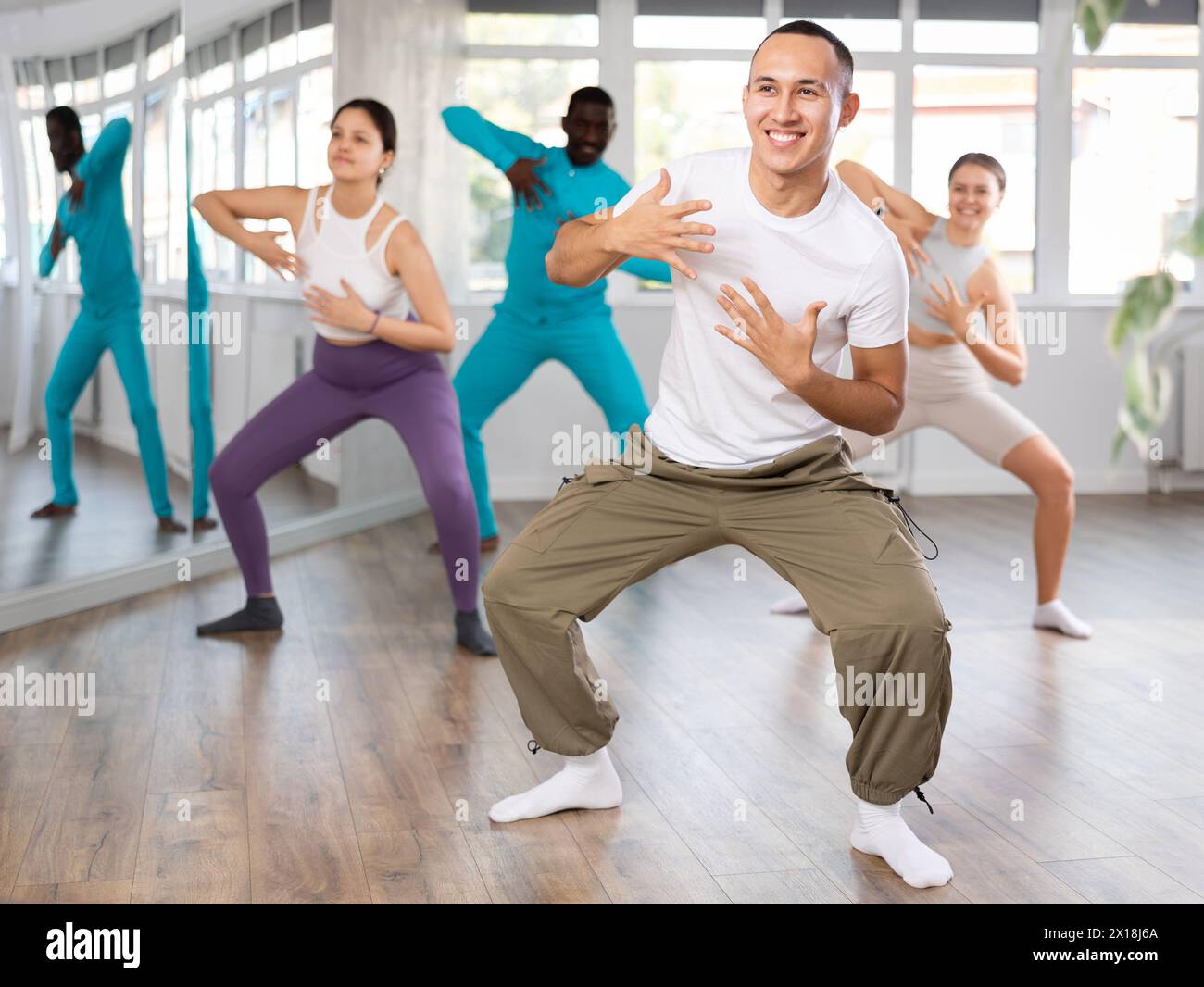 Expressive Asian guy honing hip-hop dance moves in studio Stock Photo ...