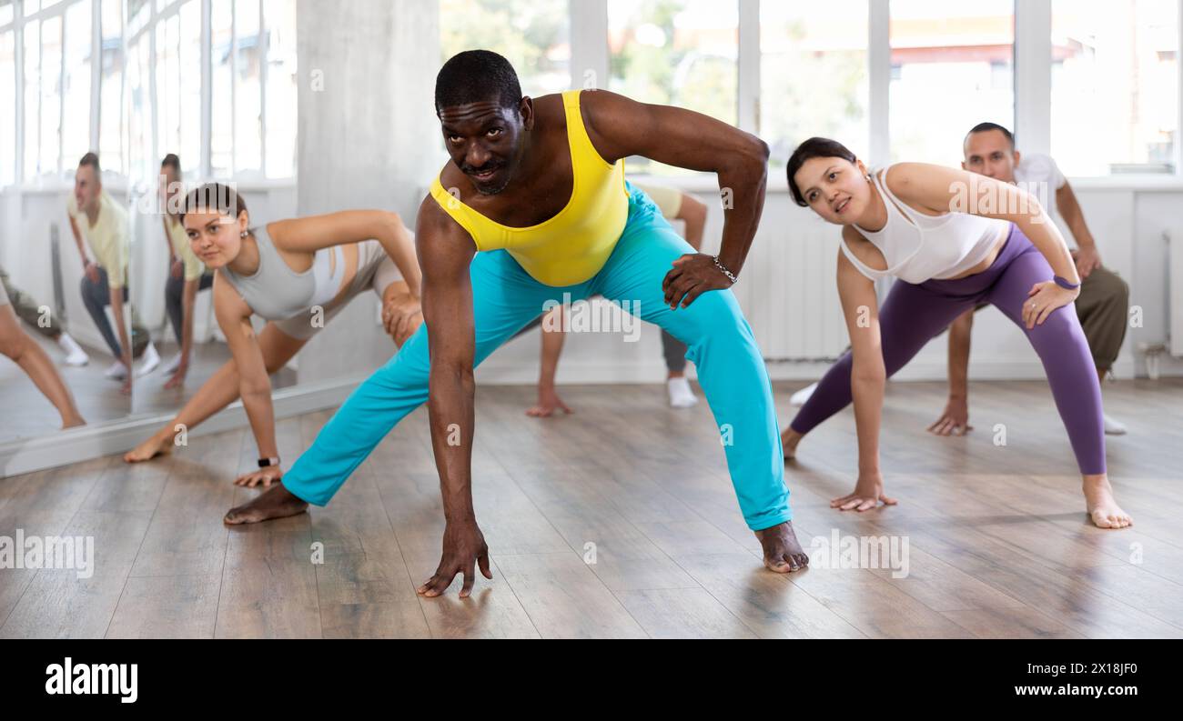 Group of people warming up before dance class Stock Photo - Alamy