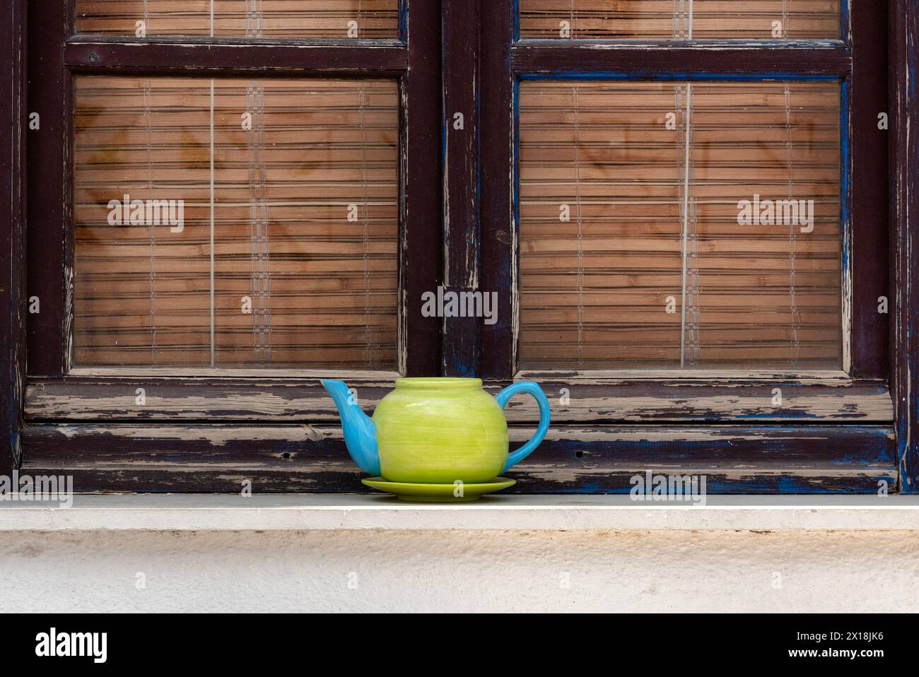 Teapot used as plant pot on window sill Stock Photo - Alamy
