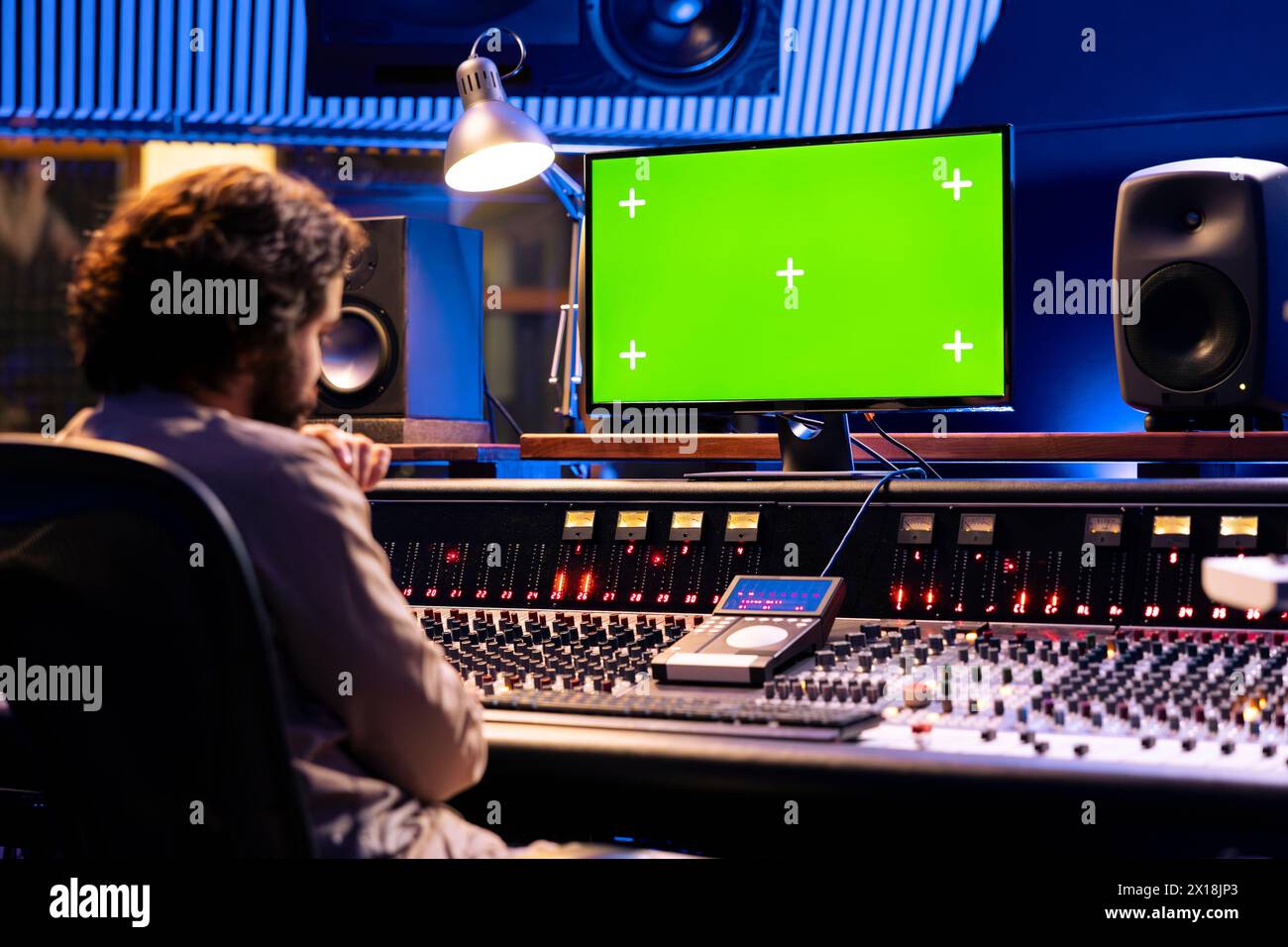 Sound engineer working with isolated display in studio control room ...