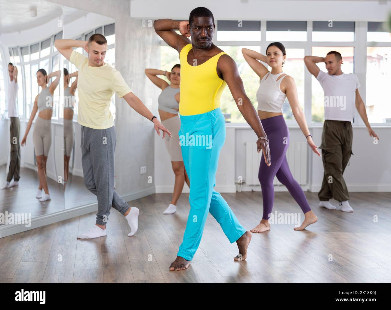African american male instructor leading fitness class Stock Photo - Alamy