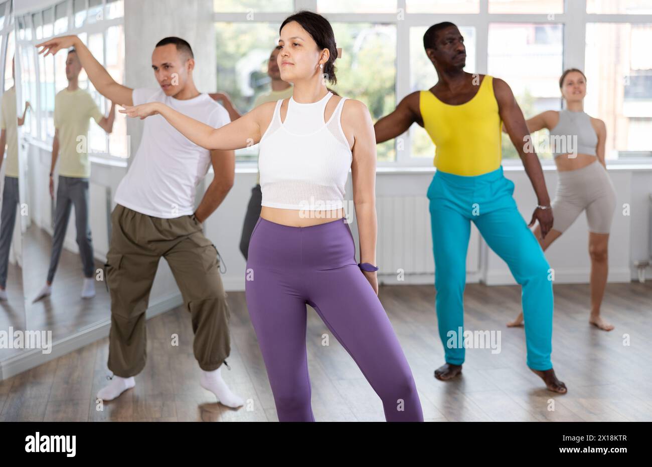 Young Asian woman practicing vigorous zumba with group Stock Photo - Alamy