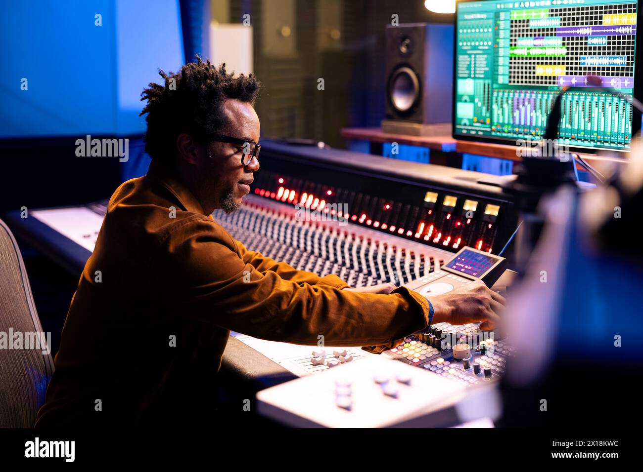 African american music producer composing tracks in control room ...
