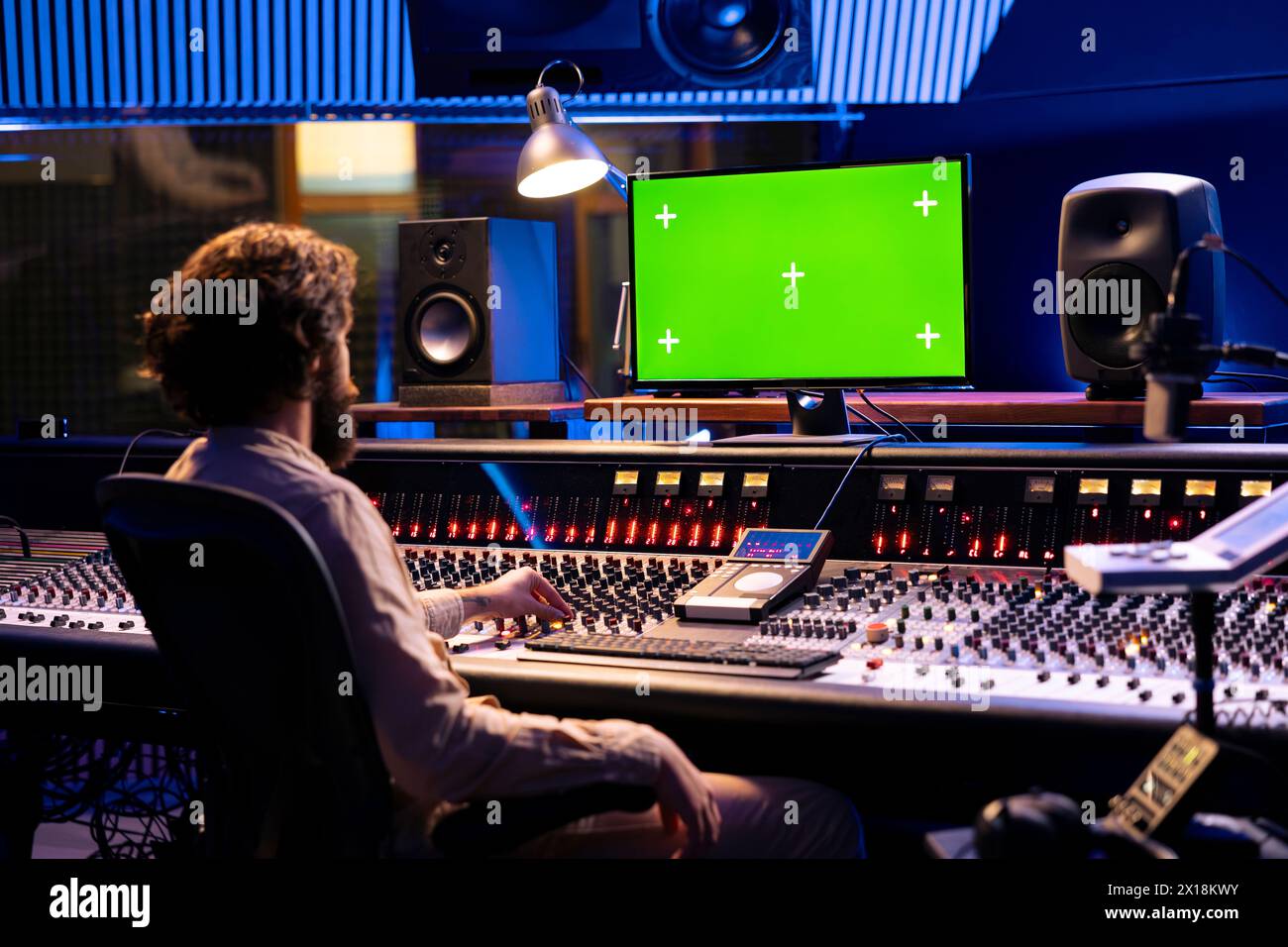 Sound designer working on mixing and mastering tracks with mockup ...